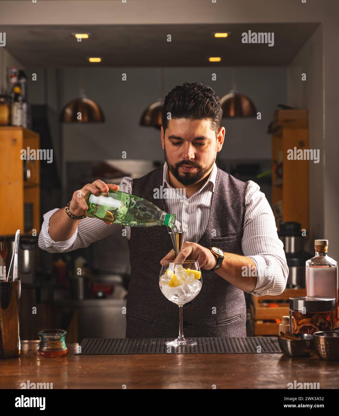 Bartender preparing cocktail, measuring alcohol with jigger on bar counter Stock Photo - Alamy