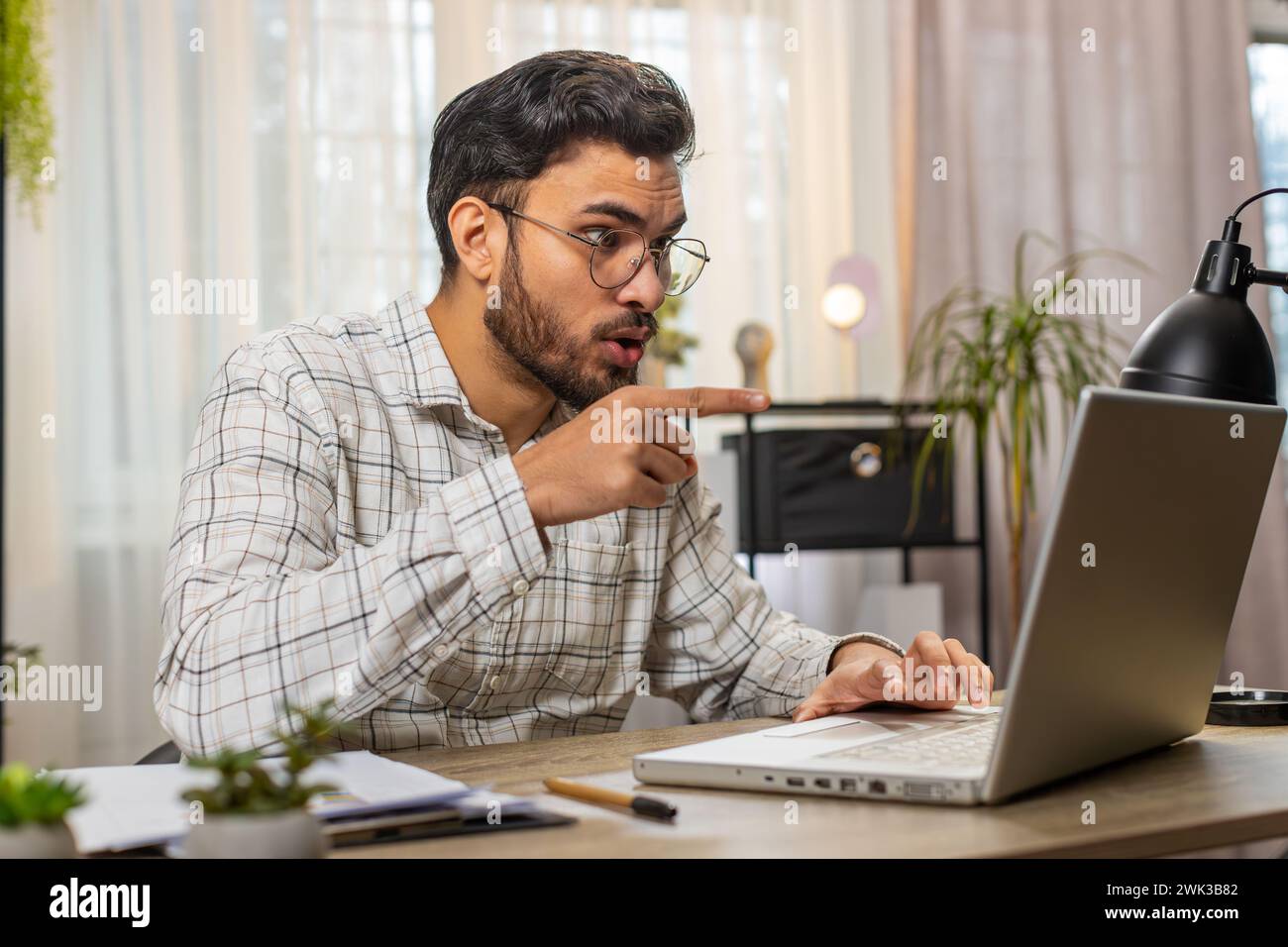 Nervous angry Arab manager quarrelling laptop call online at home ...