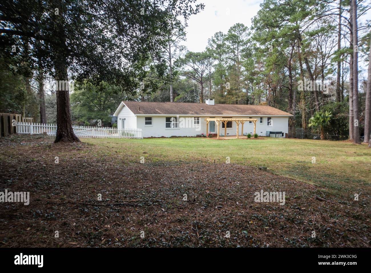 The rear back exterior of a newly painted and renovated white brick ...