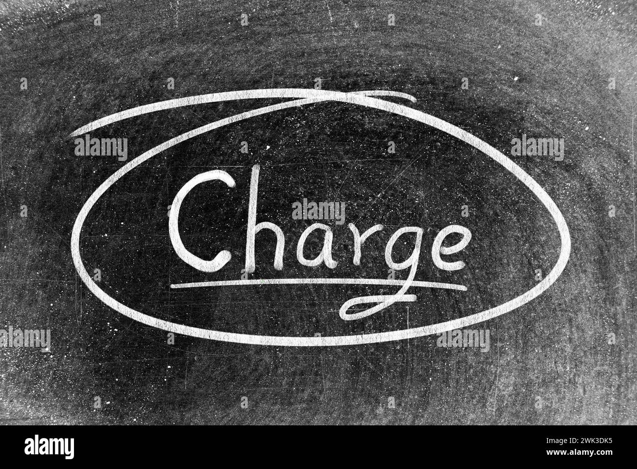 White chalk hand writing in word charge and circle shape on blackboard ...