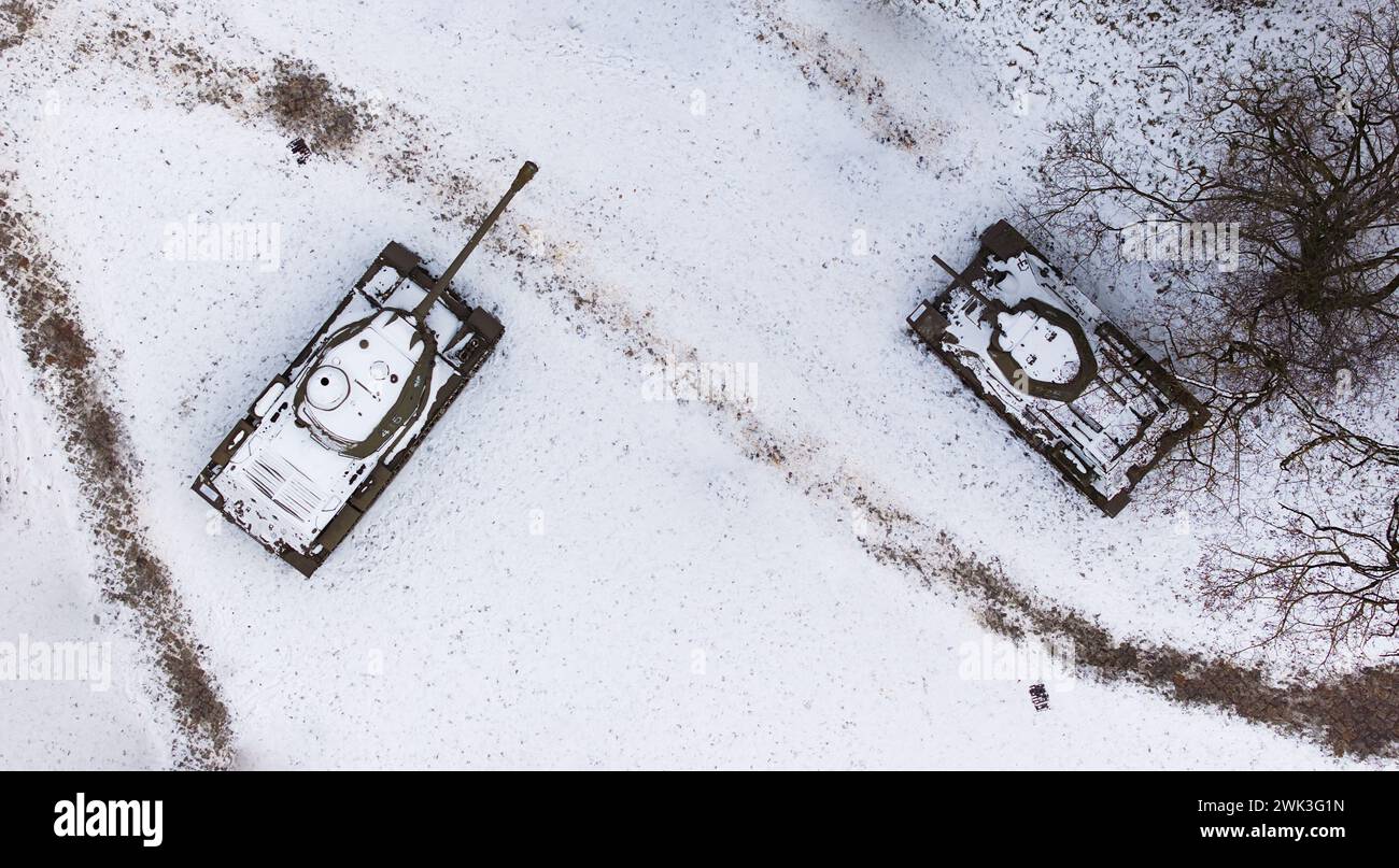 Aerial view of snow-clad tanks in Poznań Citadel during winter, shot by ...