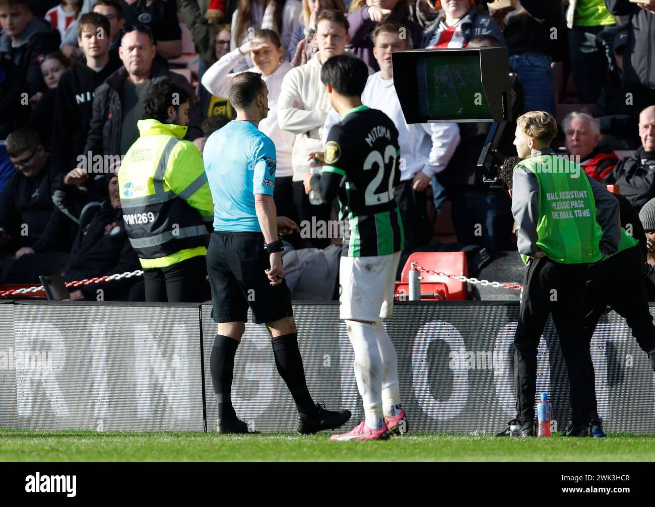 Referee Stuart Attwell views the VAR monitor before disallowing a goal ...