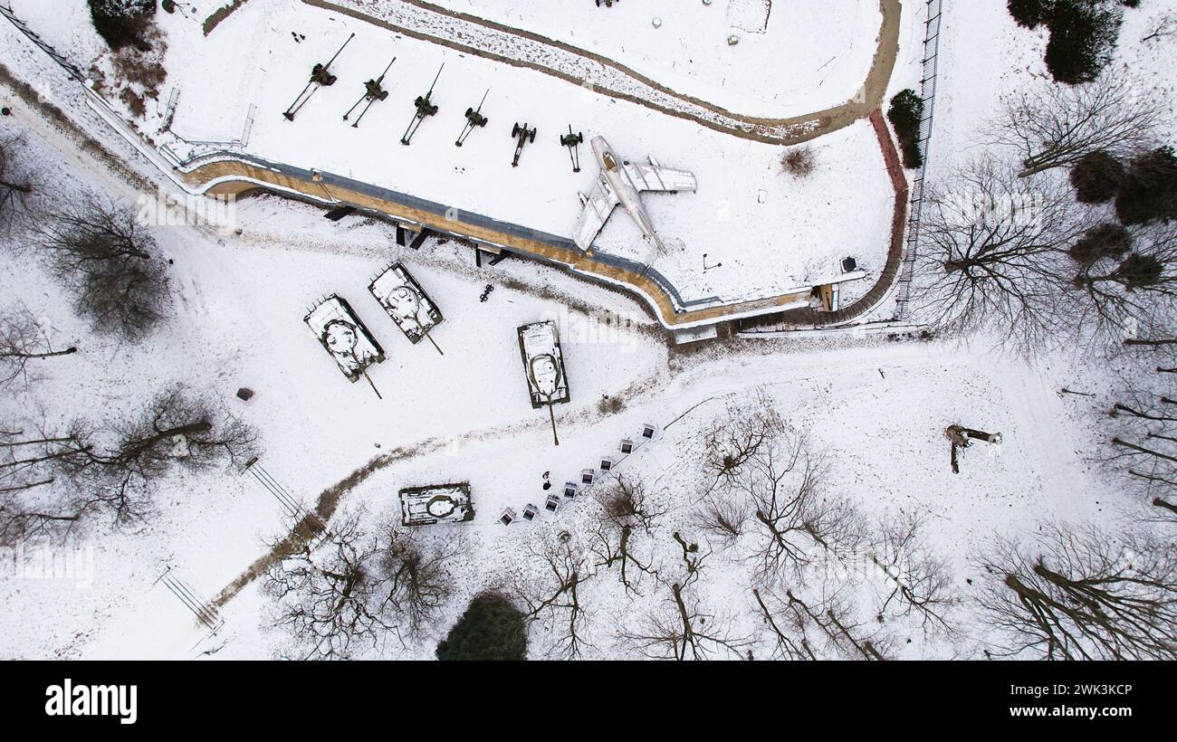 Aerial view of snow-clad tanks, artillery, and a jet fighter in Poznań ...