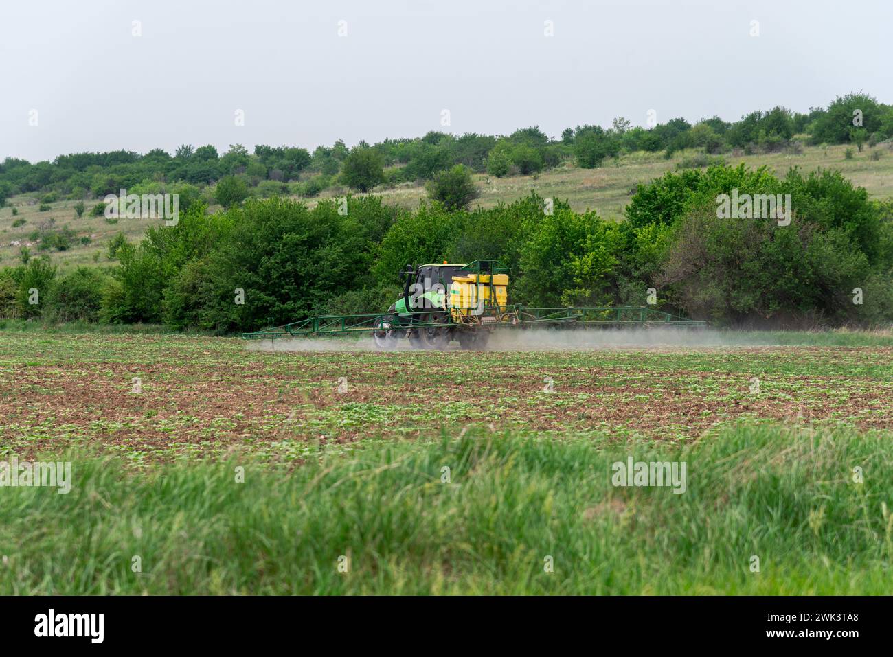 Yellow spraying tractor hi-res stock photography and images - Alamy
