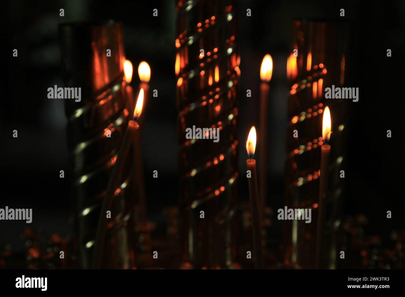 Fire of memory. Turning to God. Silent prayer. A burning candles in the ...