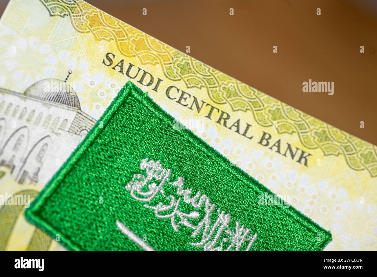 Embroidered Saudi Arabia flag and banknote with the words Saudi Central ...