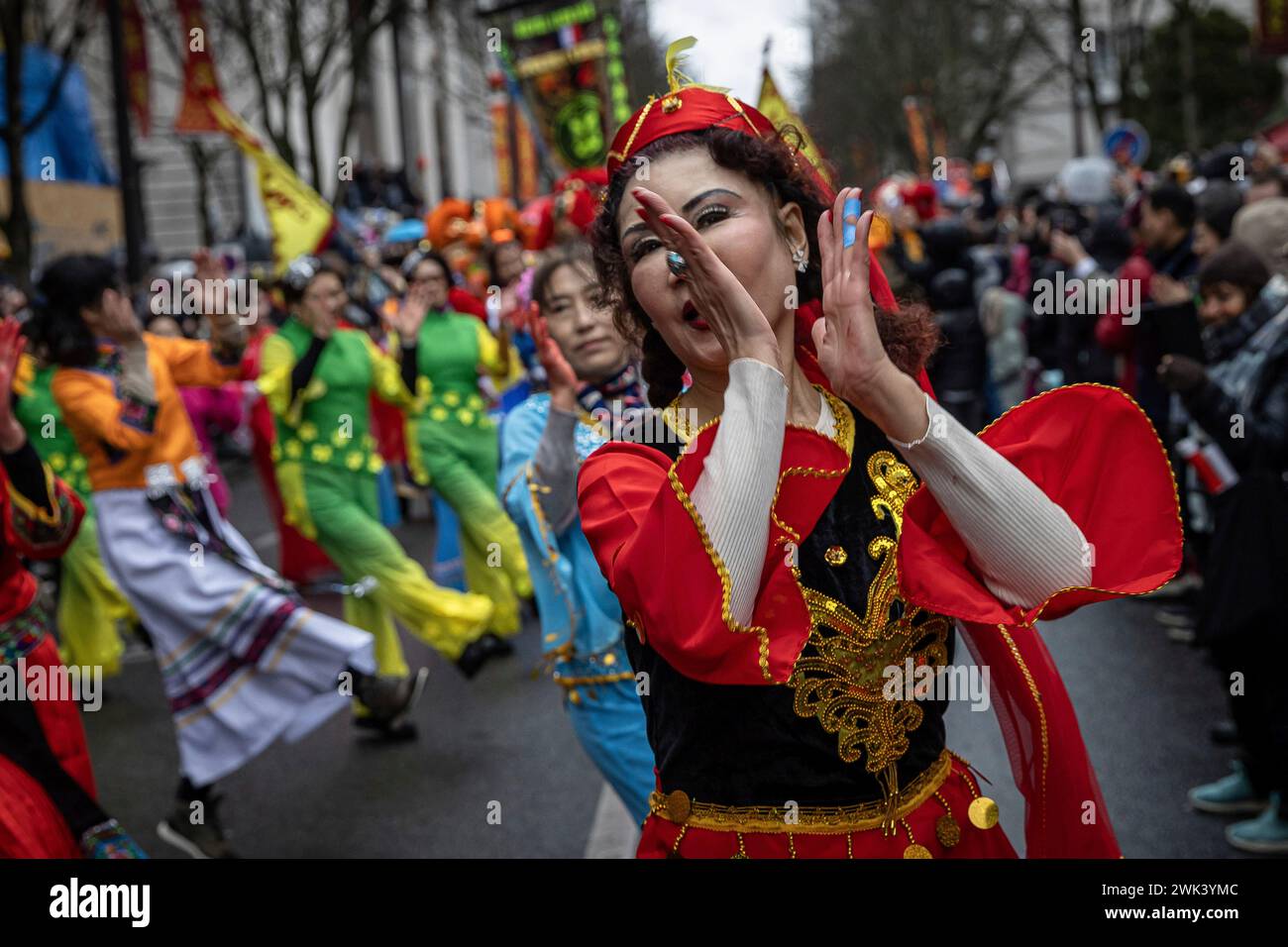 Traditionally dressed women parade in a street of the Chinatown ...