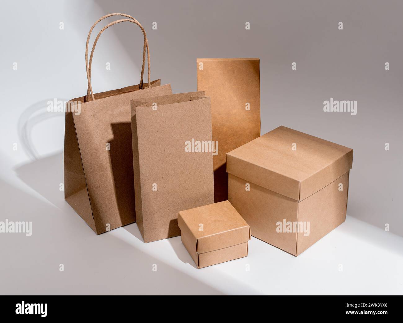 Kraft paper and cardboard packages. Carton packs arrangement Stock ...