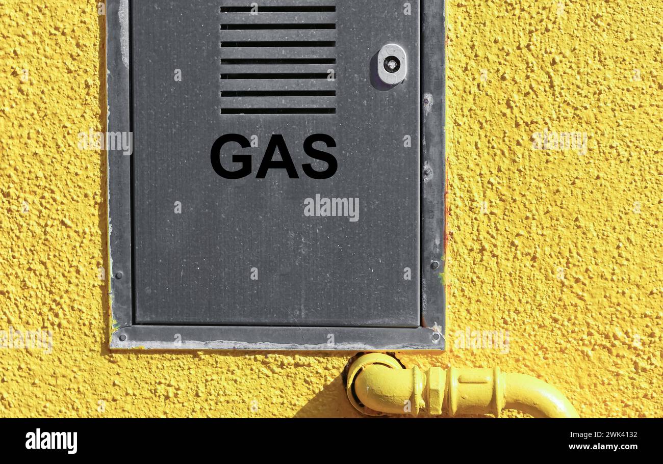 metallic door of gas meters with the text GAS and the yellow tube Stock ...