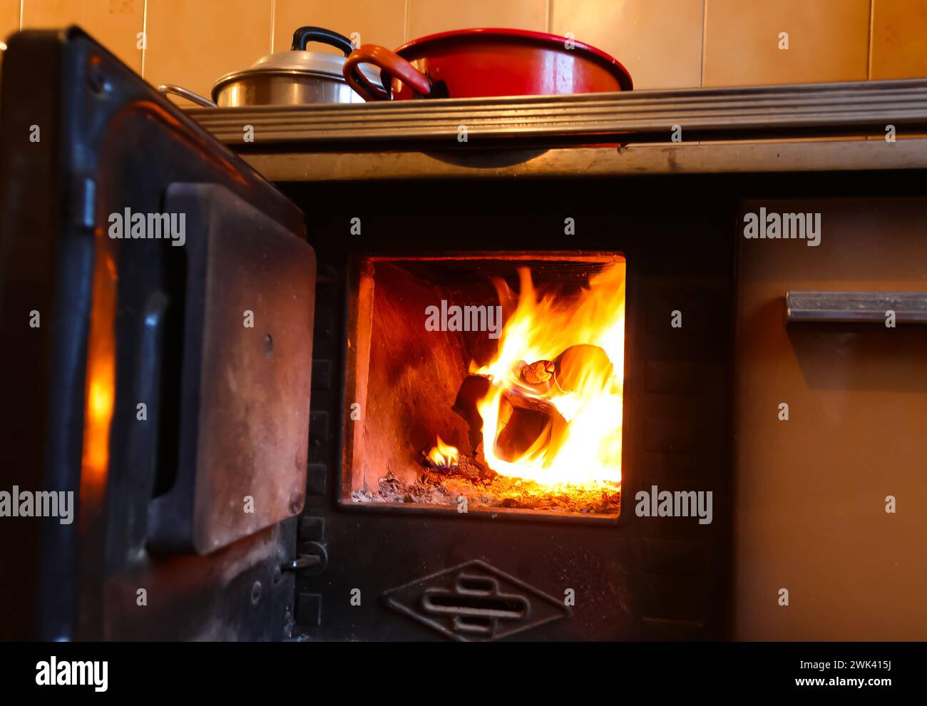 wood burning inside the ancient stove to heat the house or the dishes ...