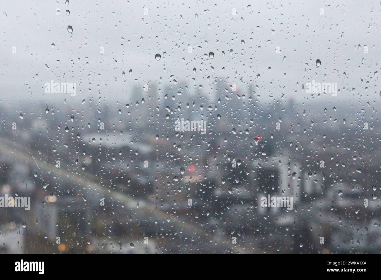 A photograph of London cityscape through a window covered in raindrops ...