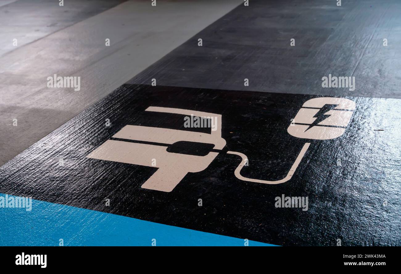 EV Charging parking space painted on car park surface Stock Photo - Alamy