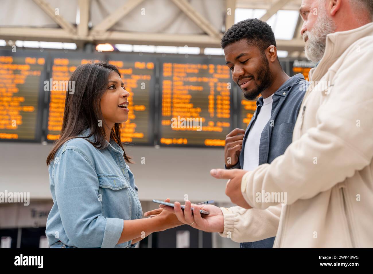 people on the train station talking about timetable changes and train ...