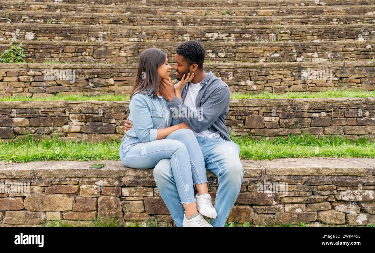 Happy young couple falling in love talking echa other, kissing, hugging ...