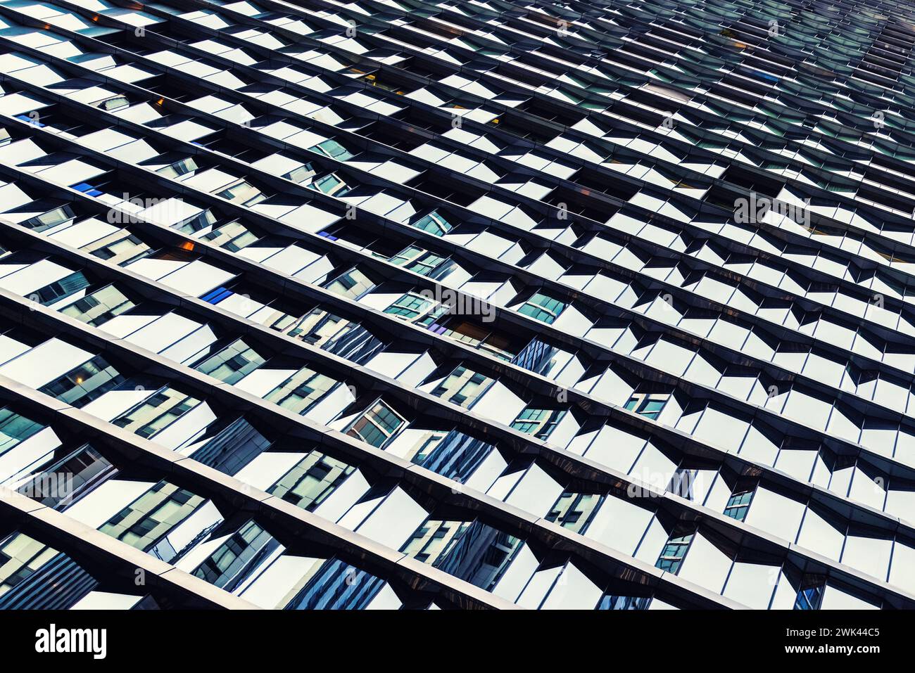 A wall of many windows and reflections, looking up at the exterior of ...