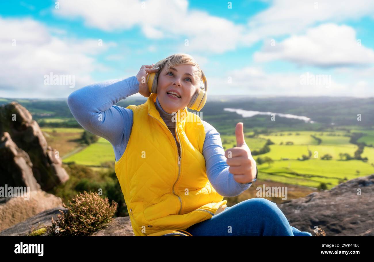 Woman reaching the destination and listening to music on the top of ...