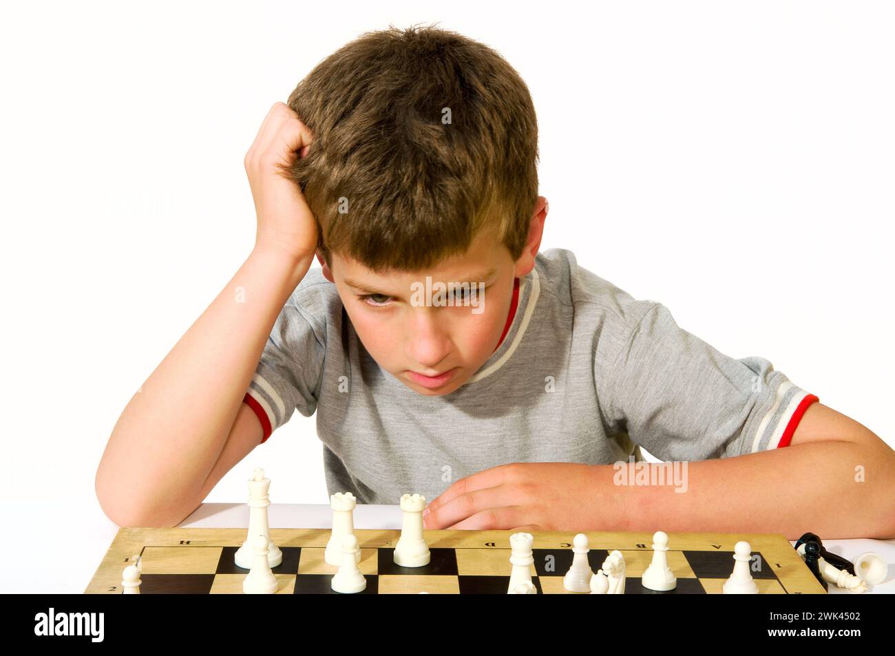 A little chess player has a difficult situation on the chessboard Stock ...