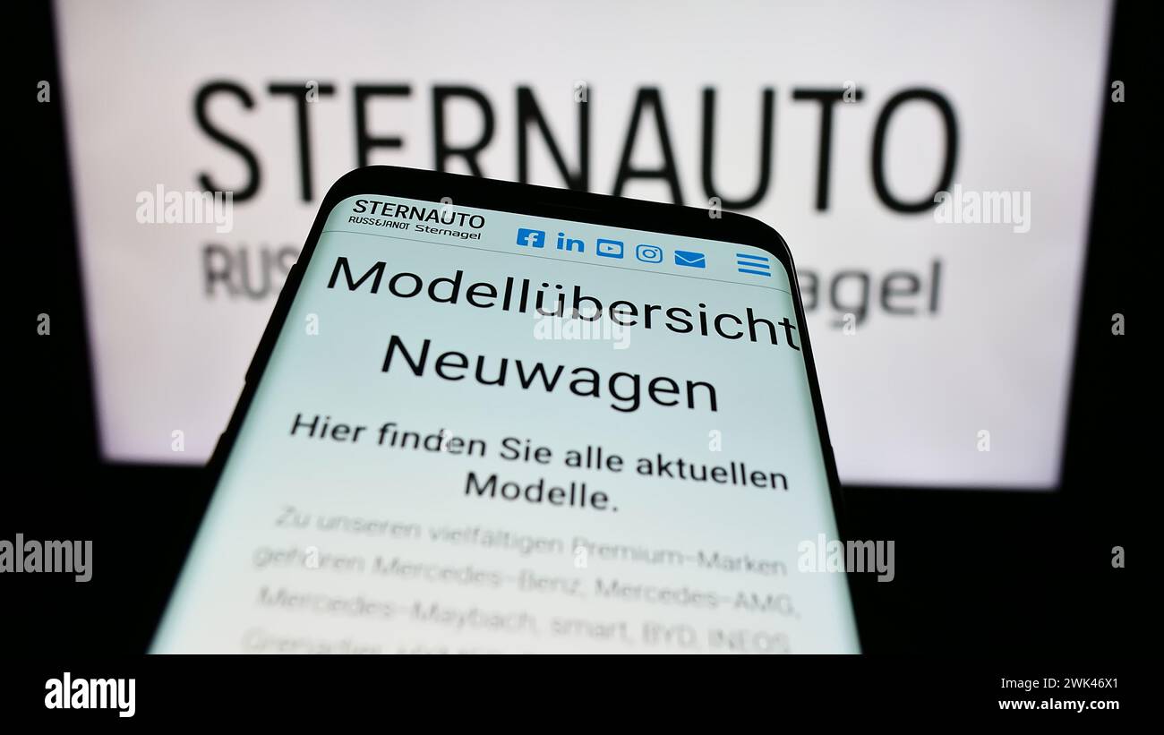 Smartphone with webpage of German car dealing company Stern Auto ...