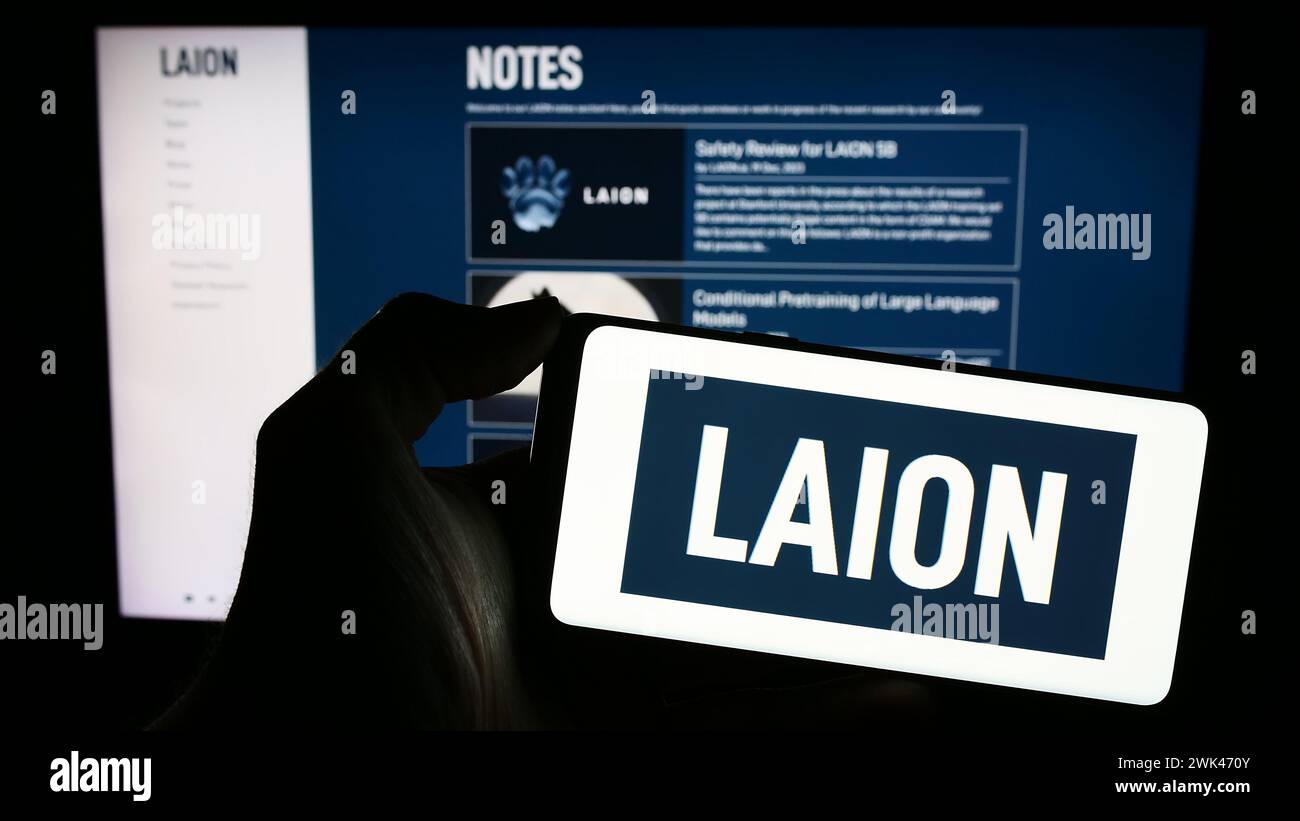 Person holding cellphone with logo of Large-scale Artificial ...