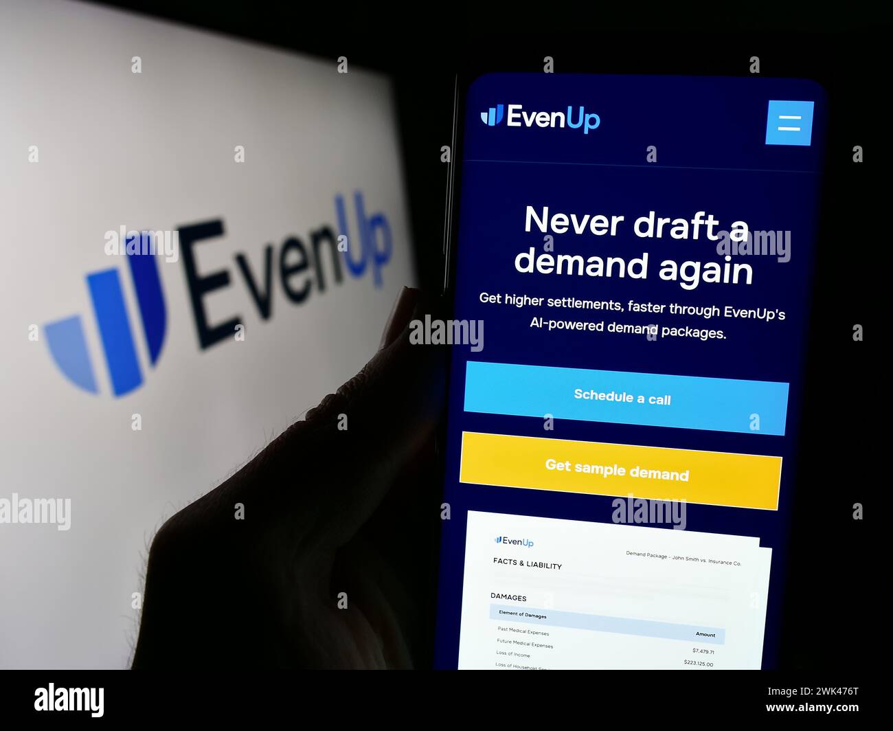 Person holding cellphone with webpage of US legal technology company ...