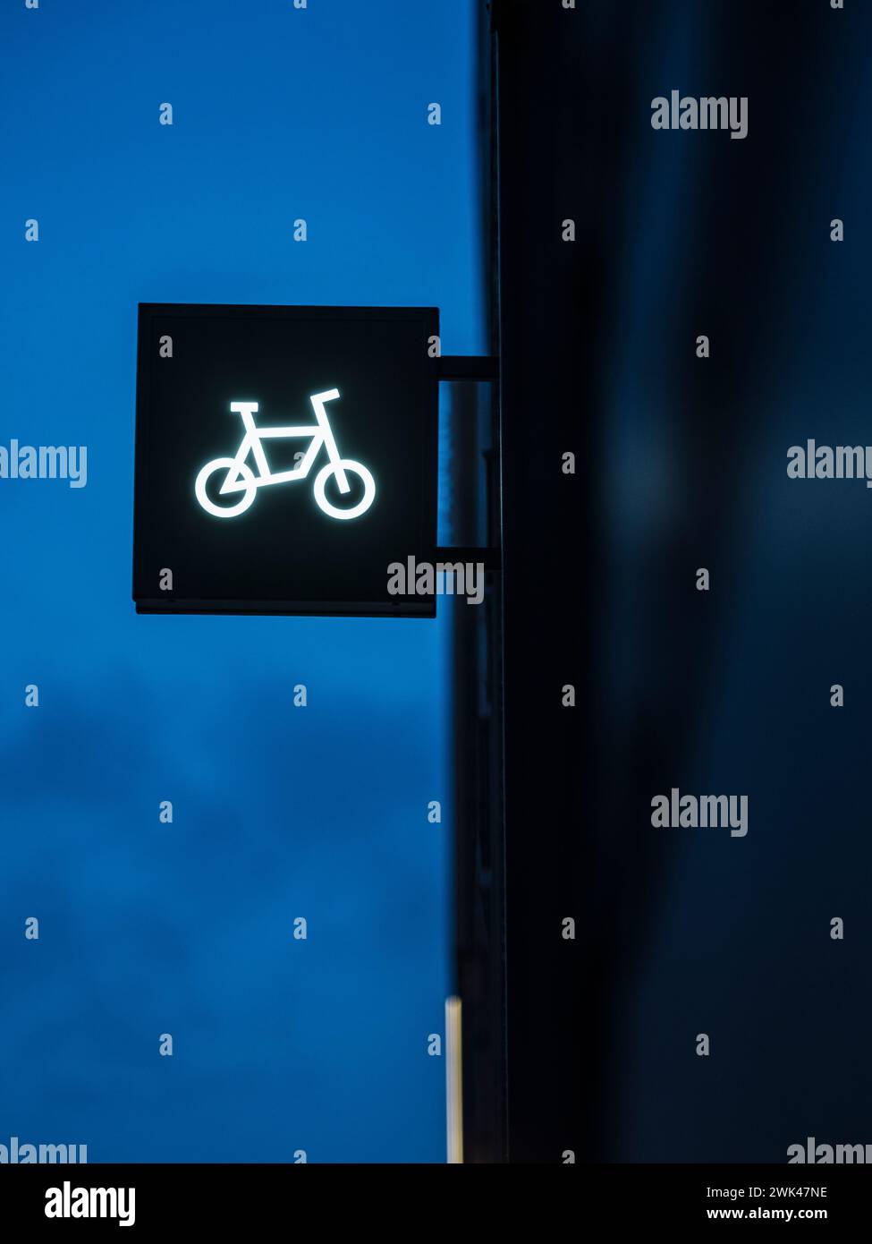 An eye-catching illuminated sign featuring a simple white line drawing ...