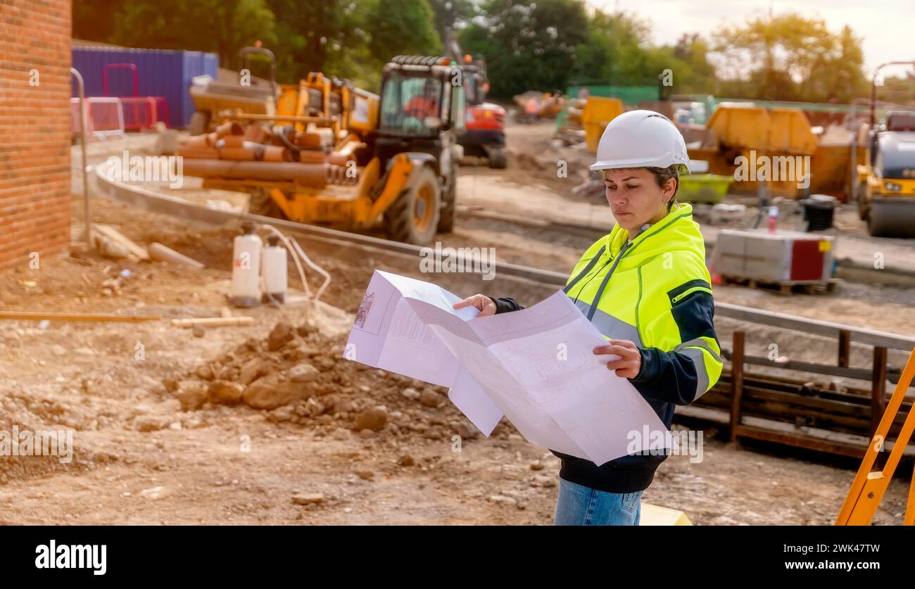Female site engineer surveyor working with theodolite total station EDM ...