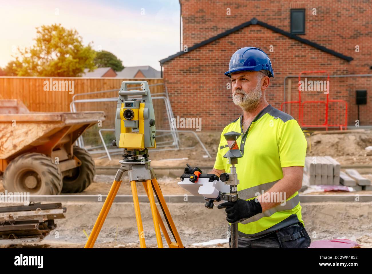 A man site engineer surveyor working with theodolite total station EDM ...