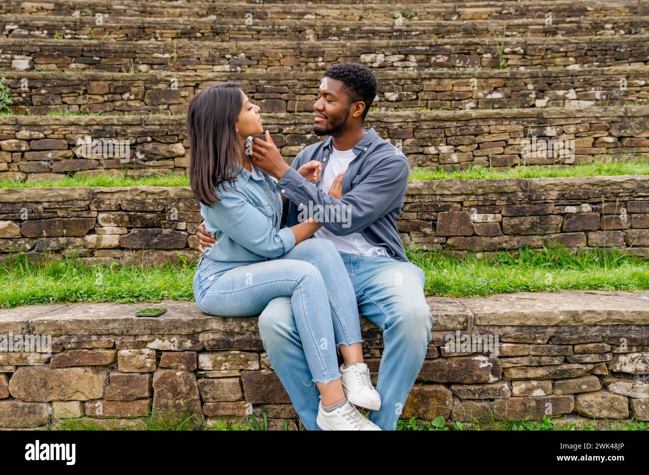 Happy young couple falling in love talking echa other, kissing, hugging ...