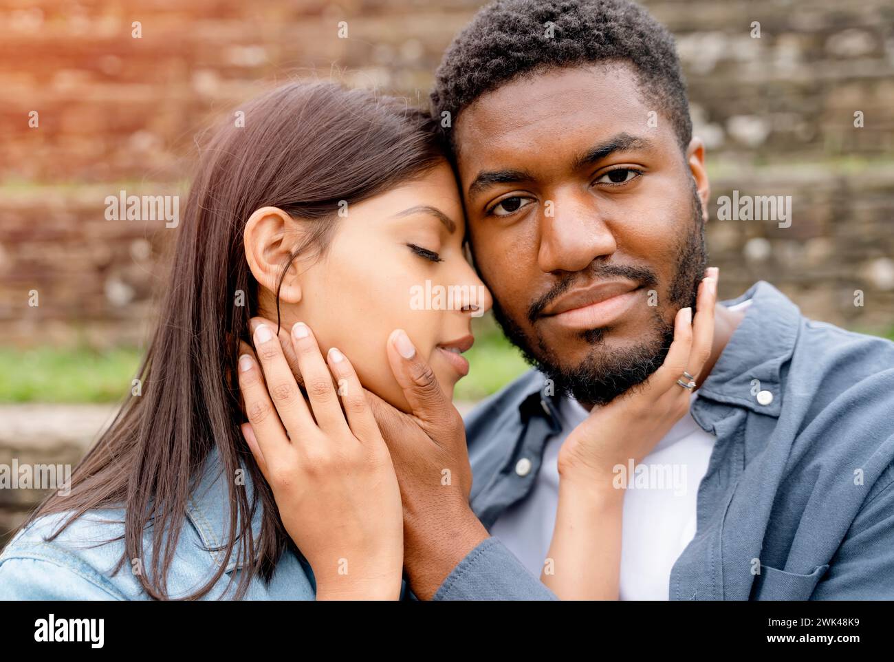 Happy young couple falling in love talking echa other, kissing, hugging ...