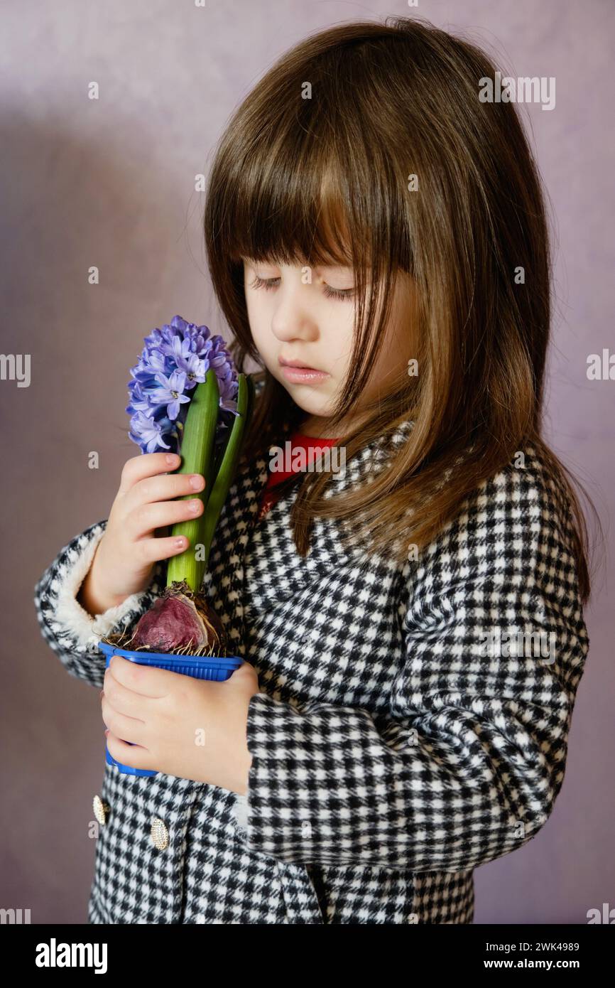 Little Girl holding hyacinth in flower pot Stock Photo - Alamy