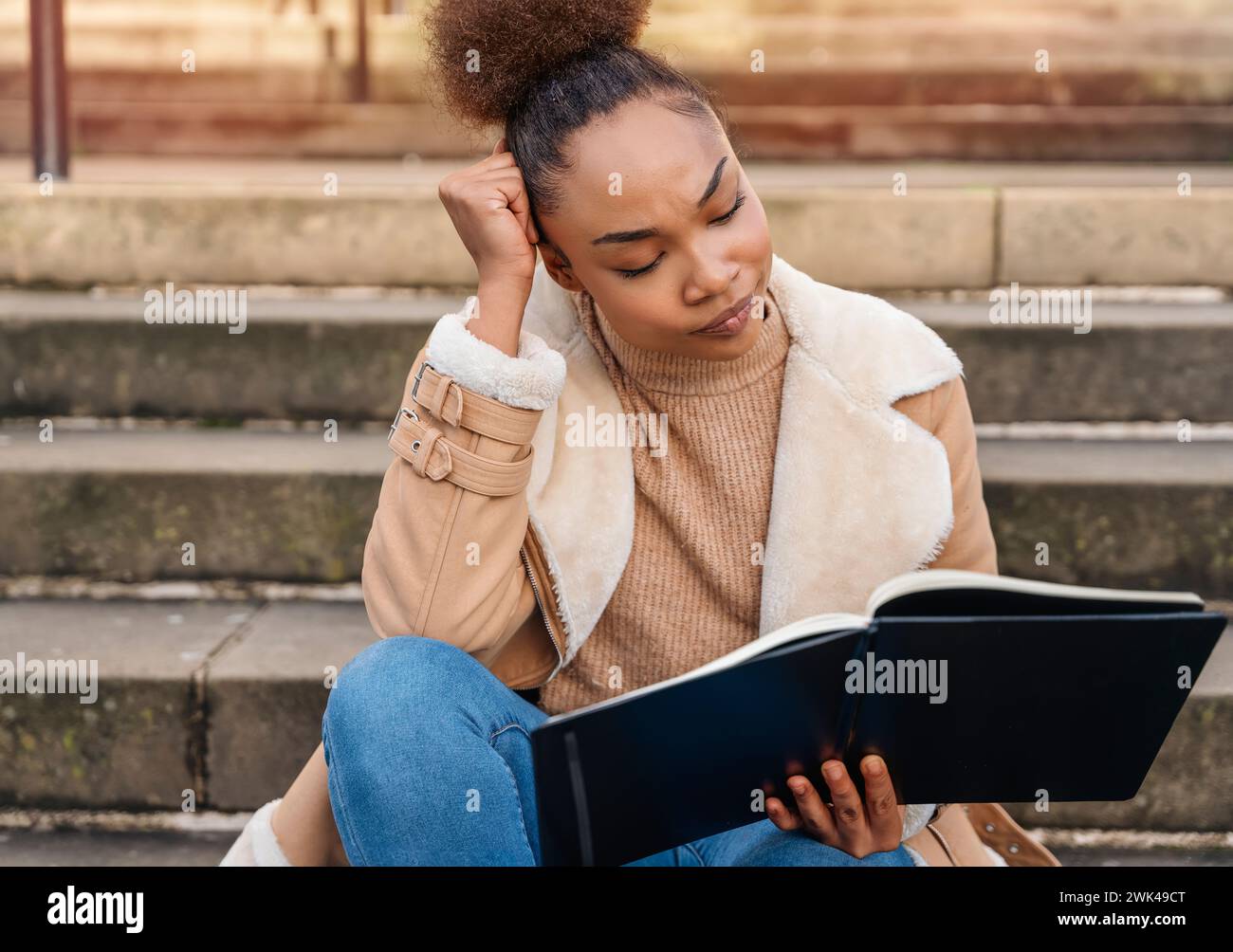 wistful concentrating African Ethnicity woman learning, reading ...