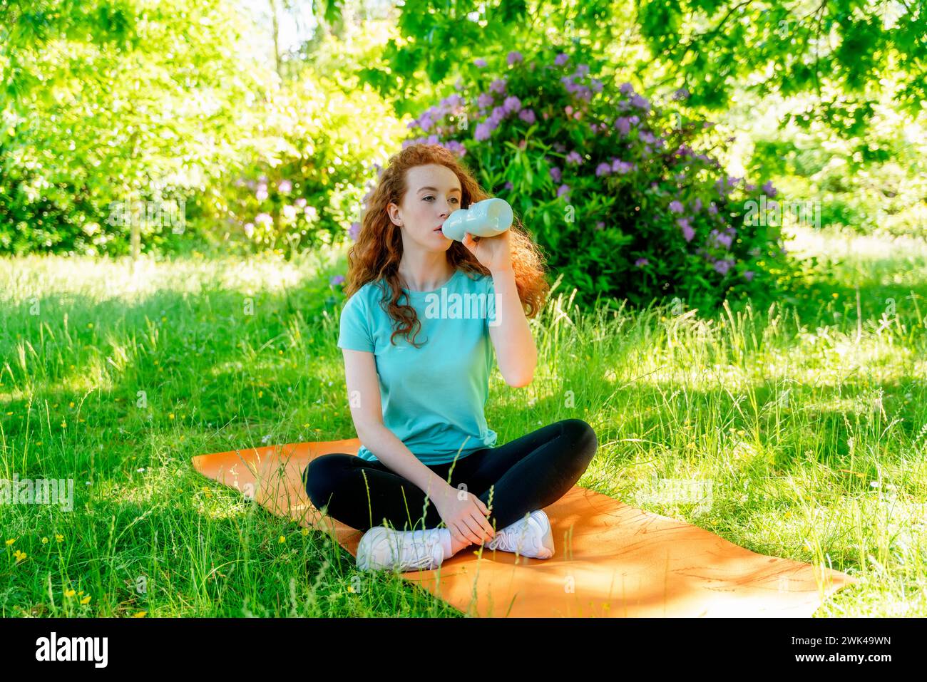 Happy tired Woman Resting and drinking water After Exercising In Park ...