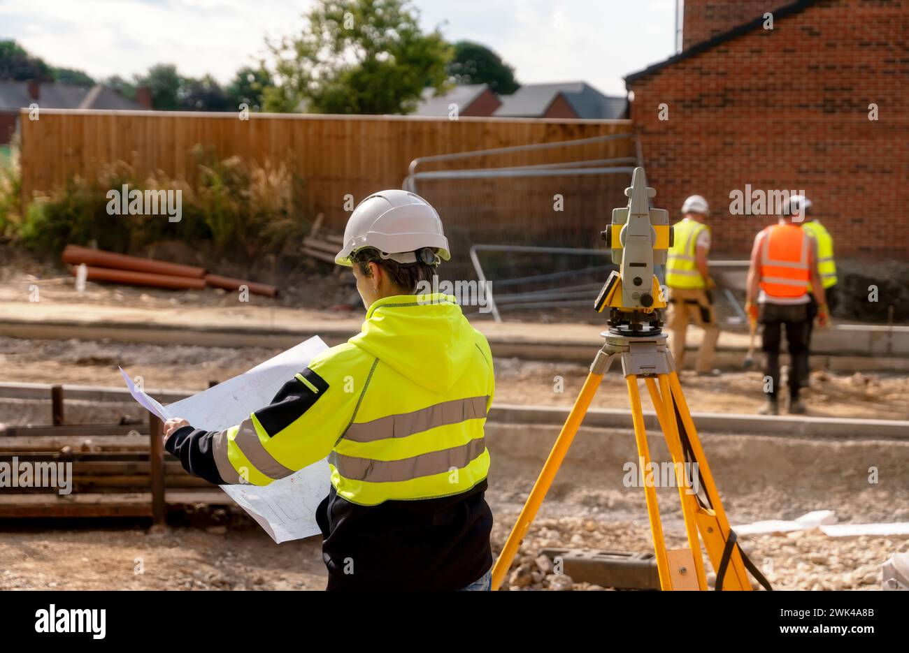 Construction site engineer woman in safety equipment working with ...