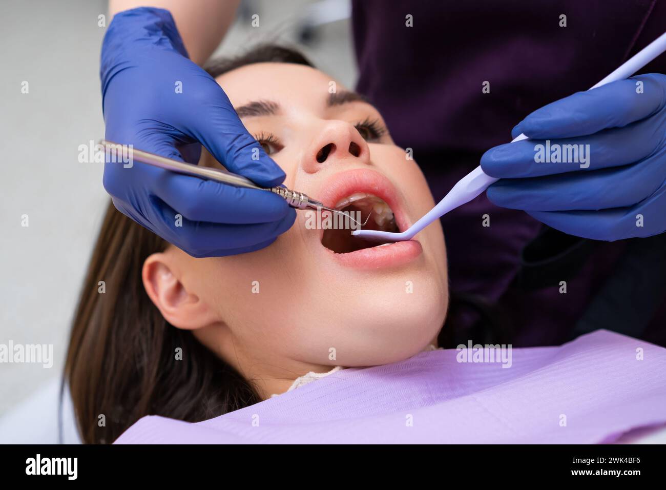 Dentist examining a patients teeth in dental office Stock Photo - Alamy