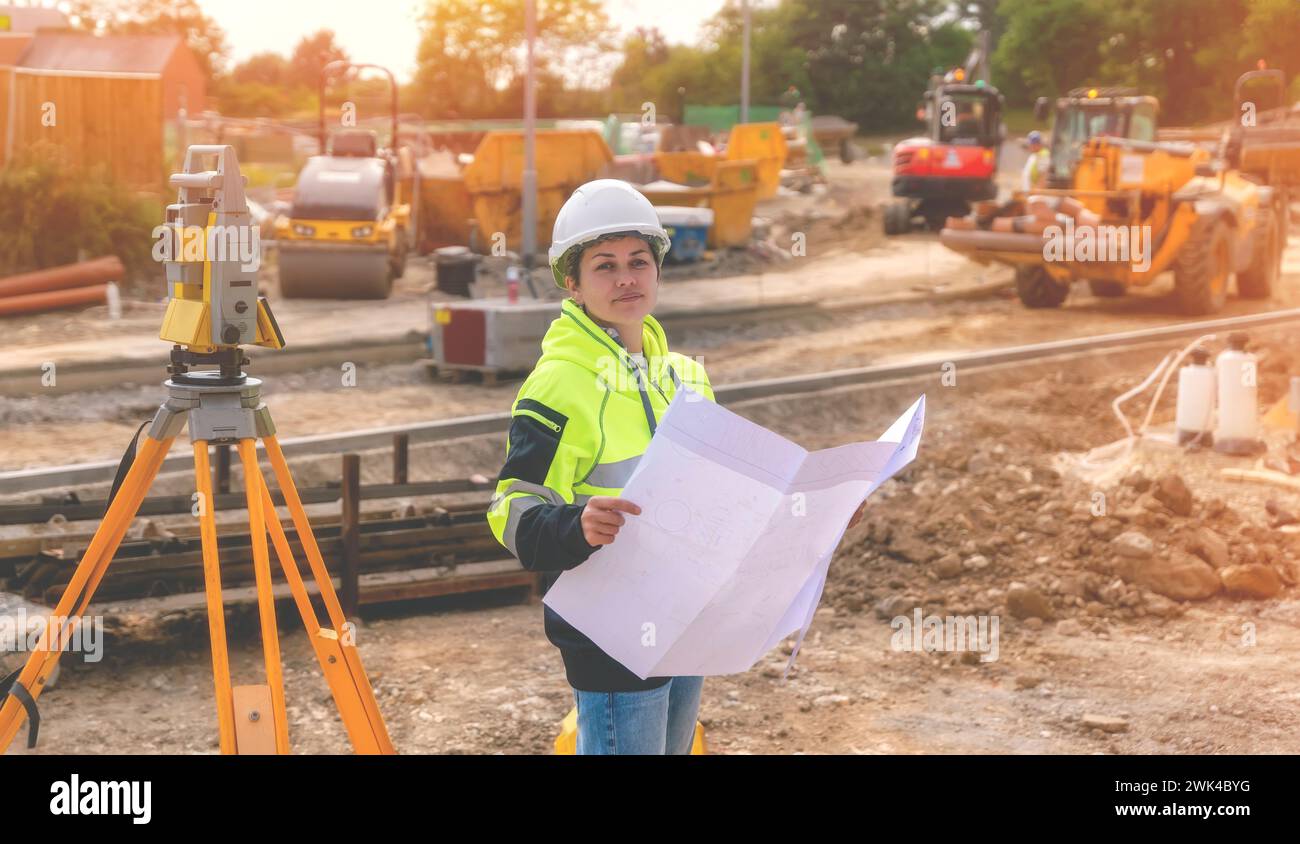 Female site engineer surveyor working with theodolite total station EDM ...