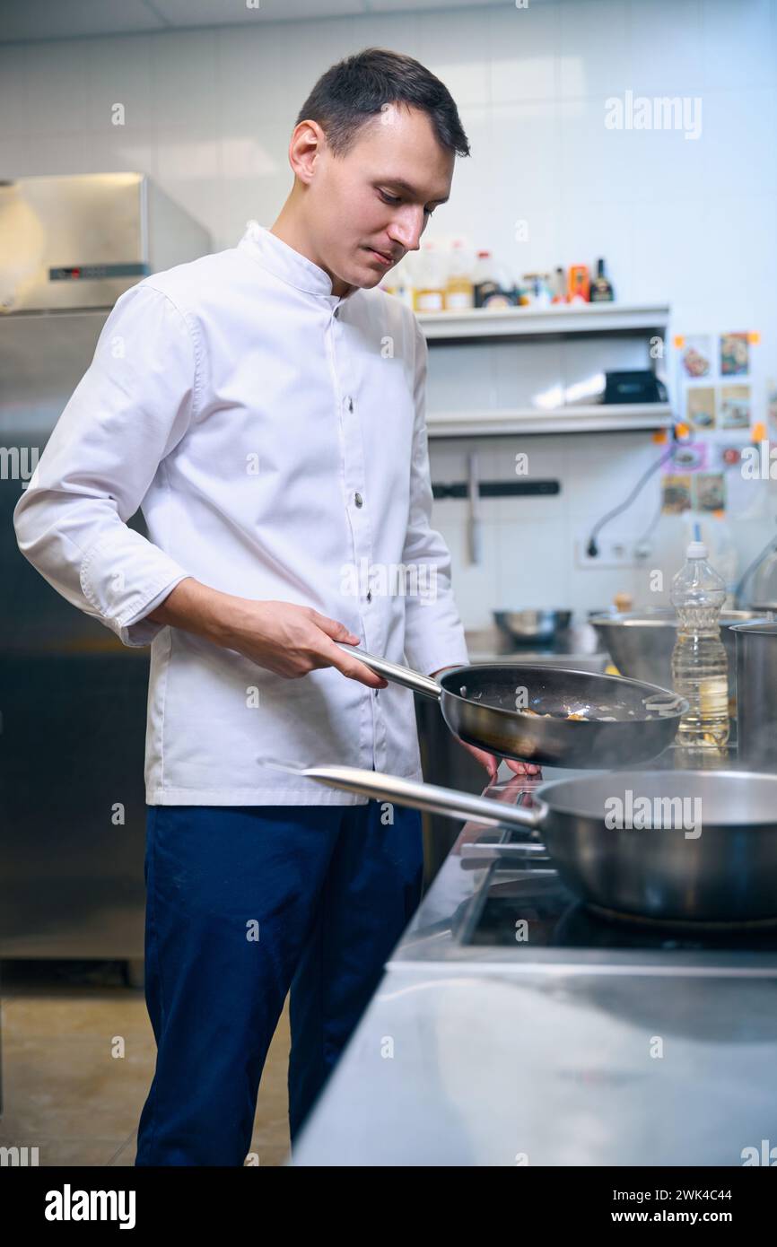 Male cooks preparing dishes hi-res stock photography and images - Alamy