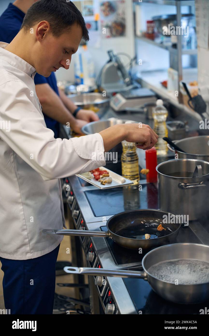 Restaurant kitchen employee cutting hi-res stock photography and images ...