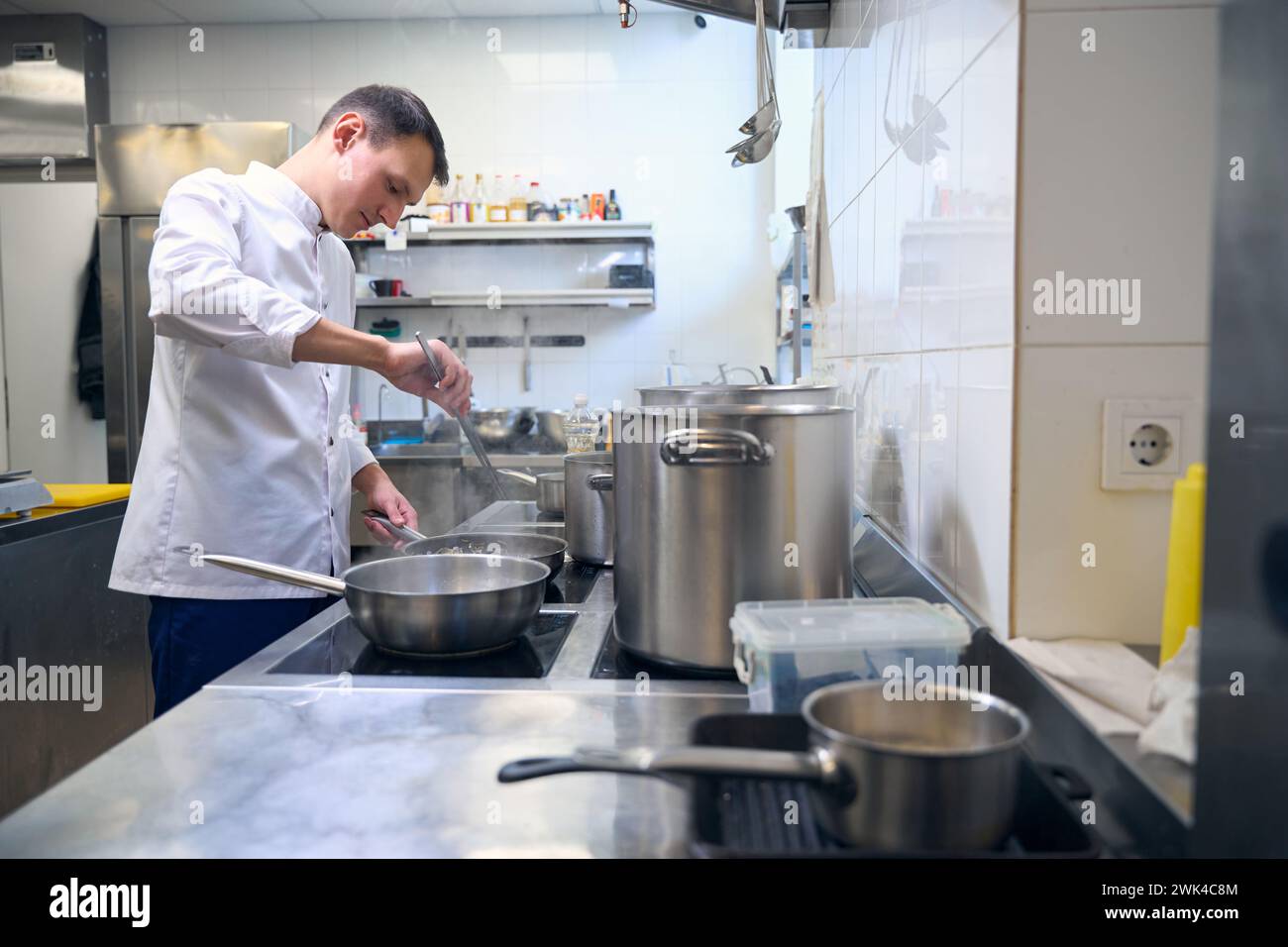 Chef prepares vegetables in frying hi-res stock photography and images ...