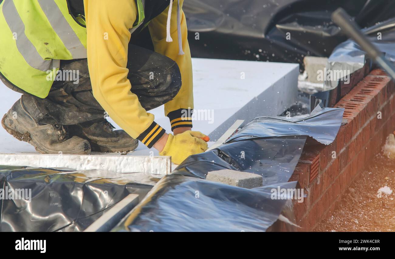 Installation of sheet of expanded polystyrene under concrete floor for ...