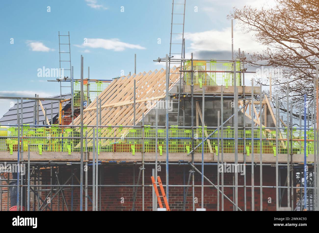 Roofers at work, installation of a new covering of a tiled roof ...