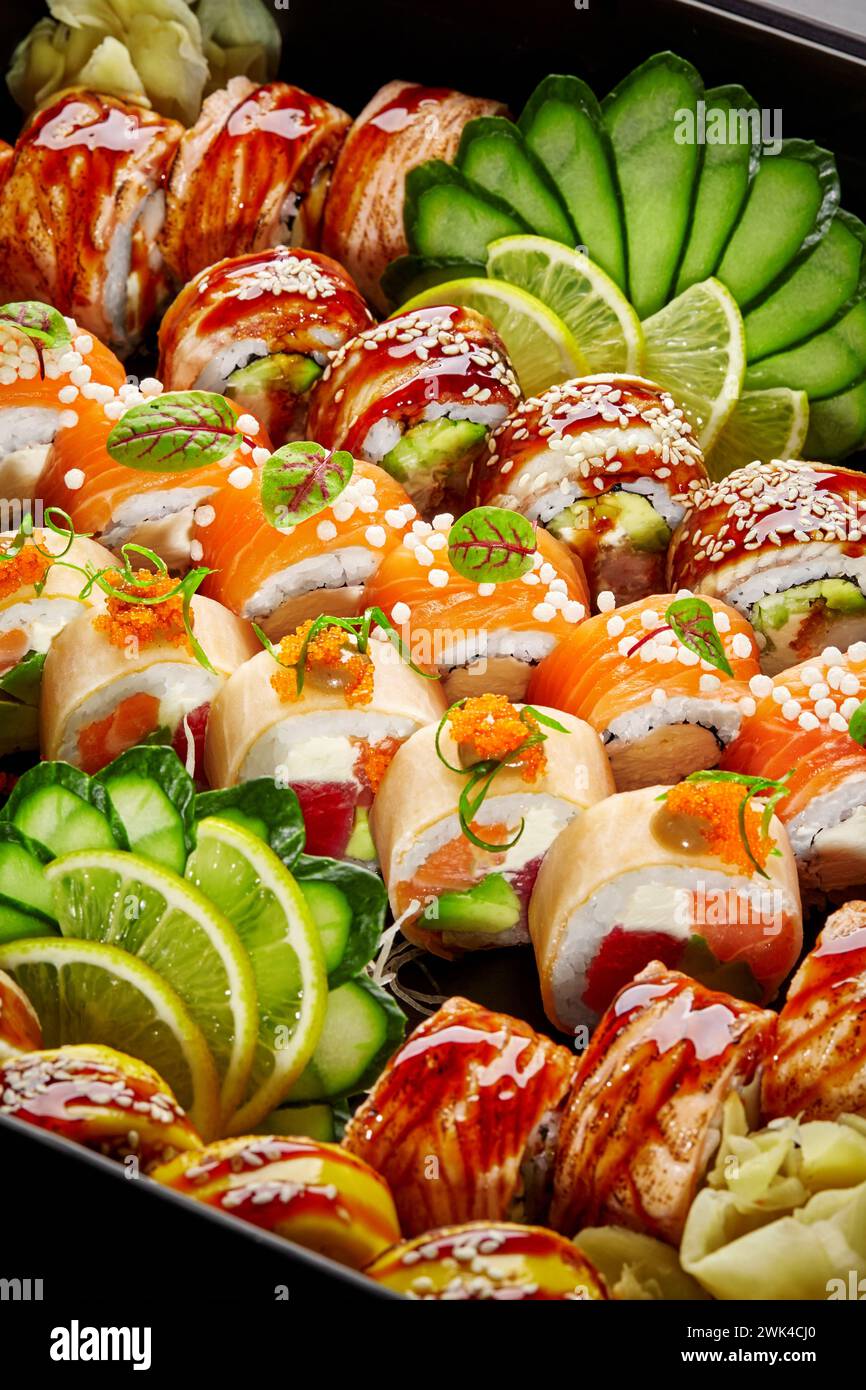 Various sushi rolls packed in black cardboard box Stock Photo - Alamy