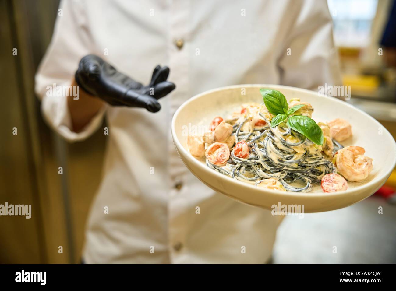 Restaurant kitchen employee presents hi-res stock photography and ...