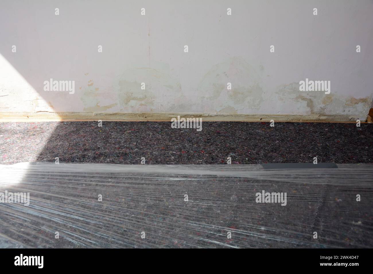A room in an apartment during renovation with the floor taped off to ...