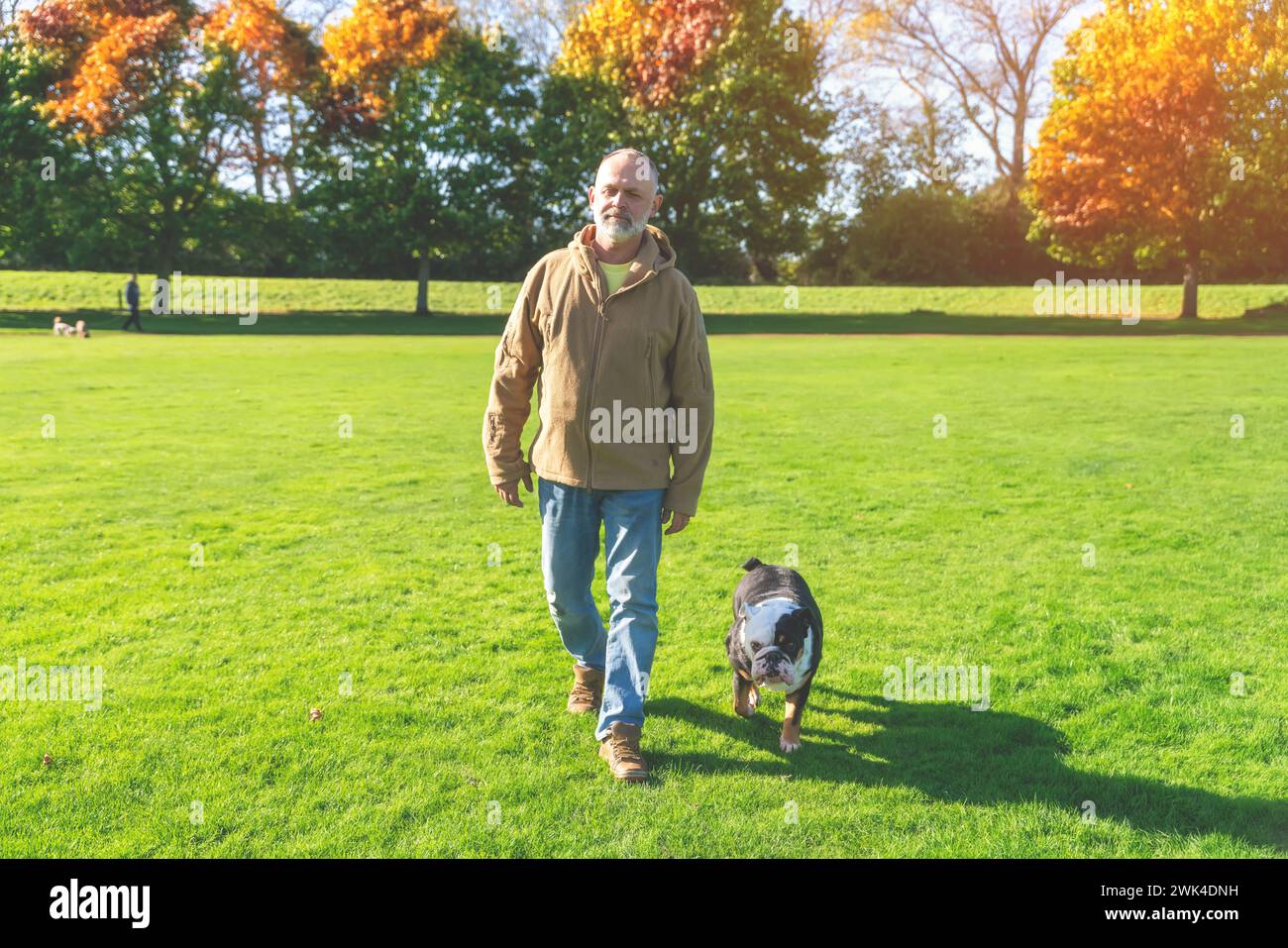 Old man walking dog with friend hi-res stock photography and images - Alamy