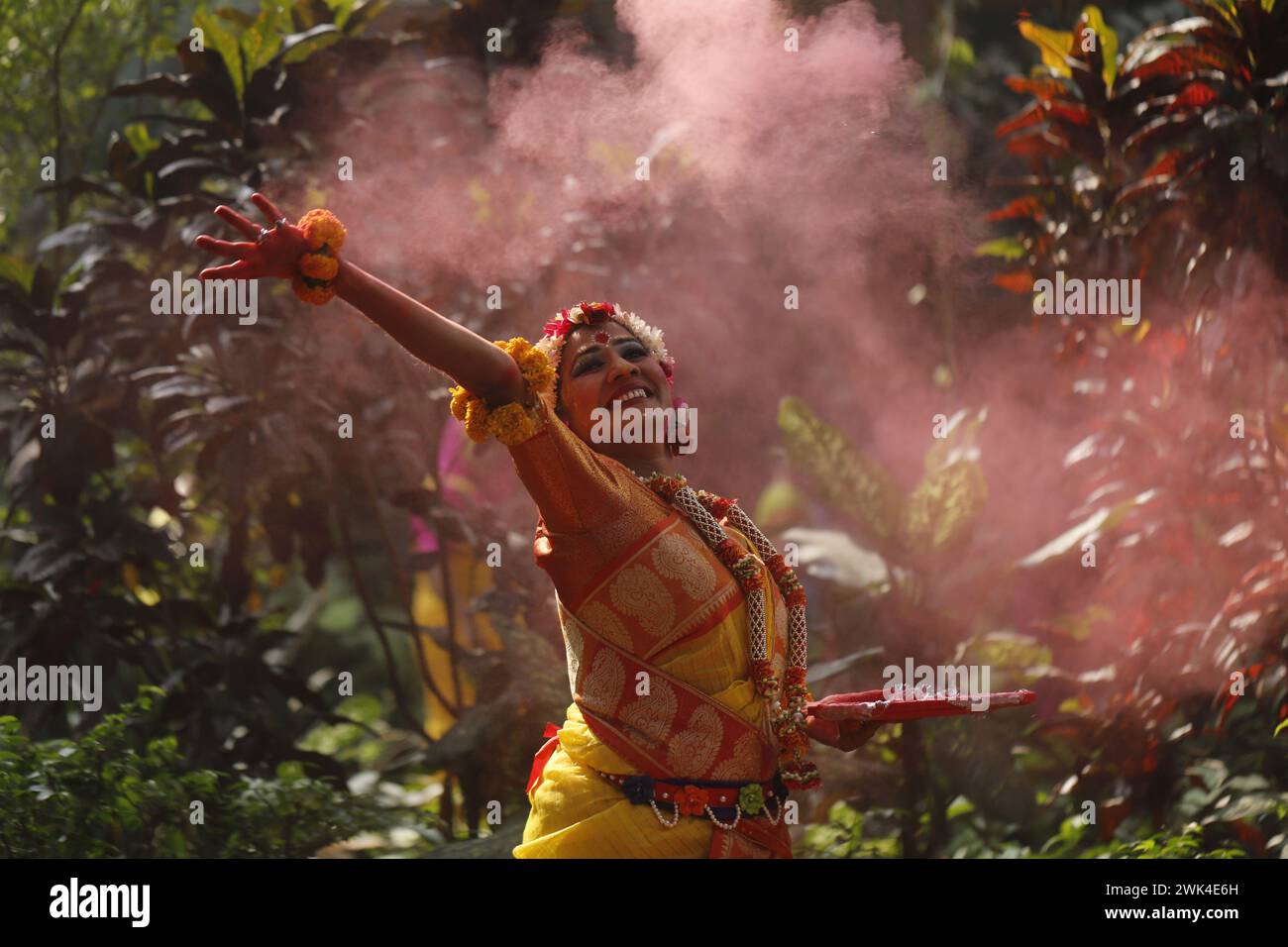 A woman is playing with colors during the Spring Festival in Dhaka ...