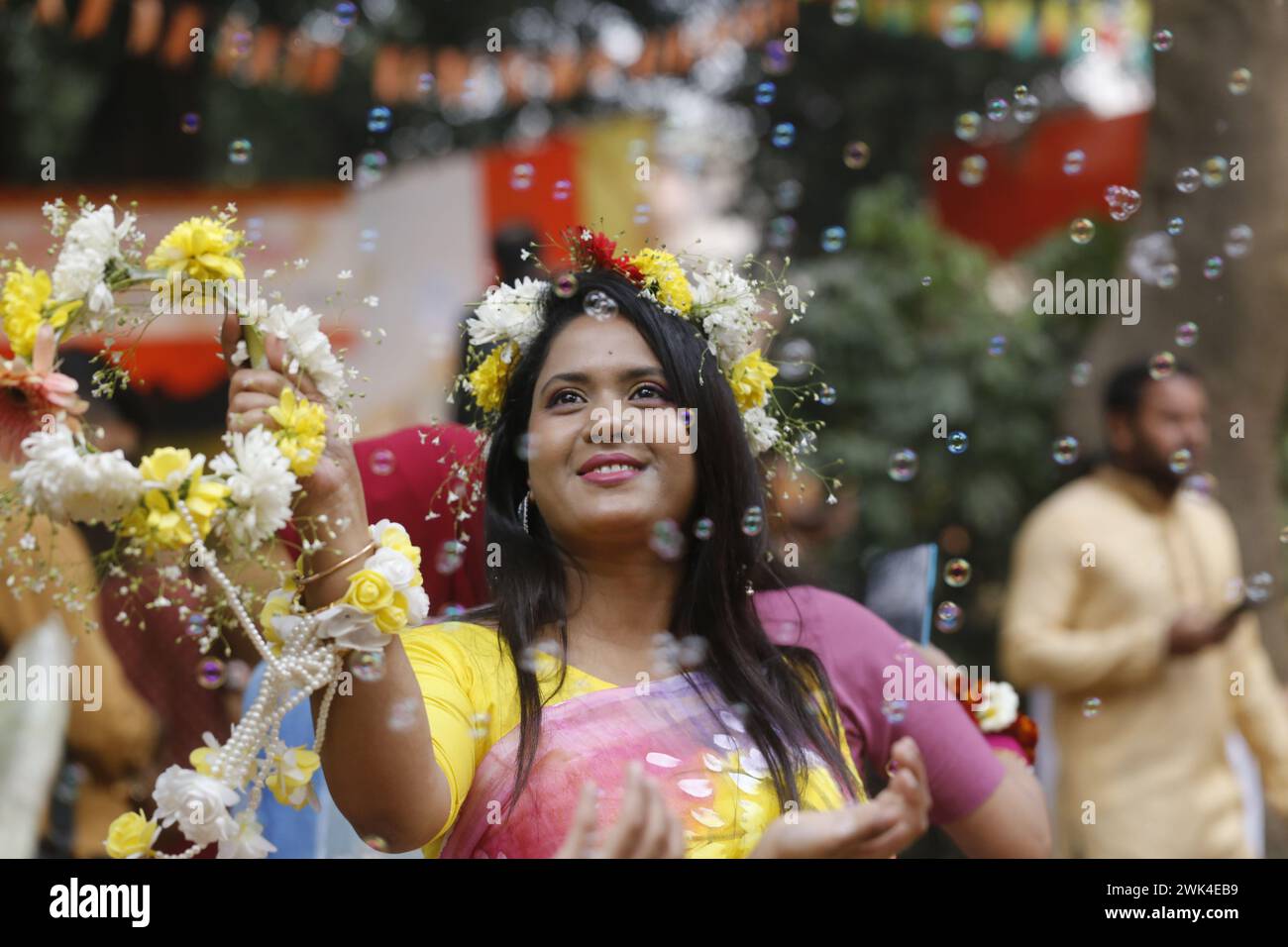 A woman is playing with bubble during the Spring Festival in Dhaka, Bangladesh on February 14 ...