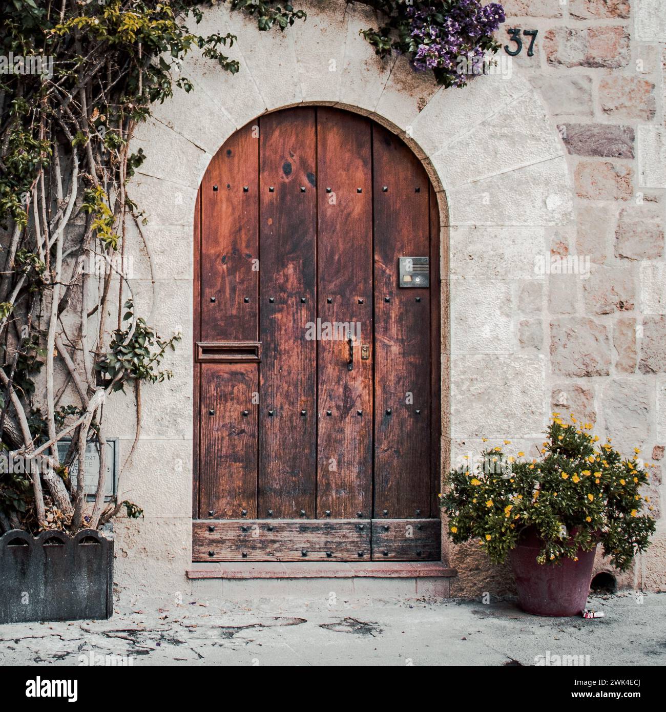 Brown wooden old door made from slats photo. Grey brick house ...