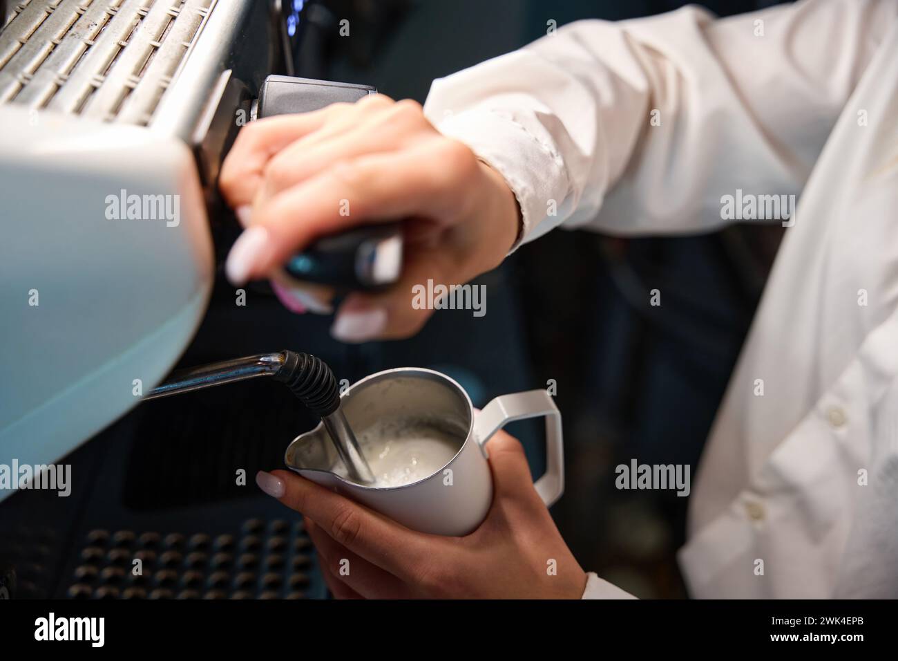 Barista prepares coffee with milk foam in a coffee machine Stock Photo - Alamy