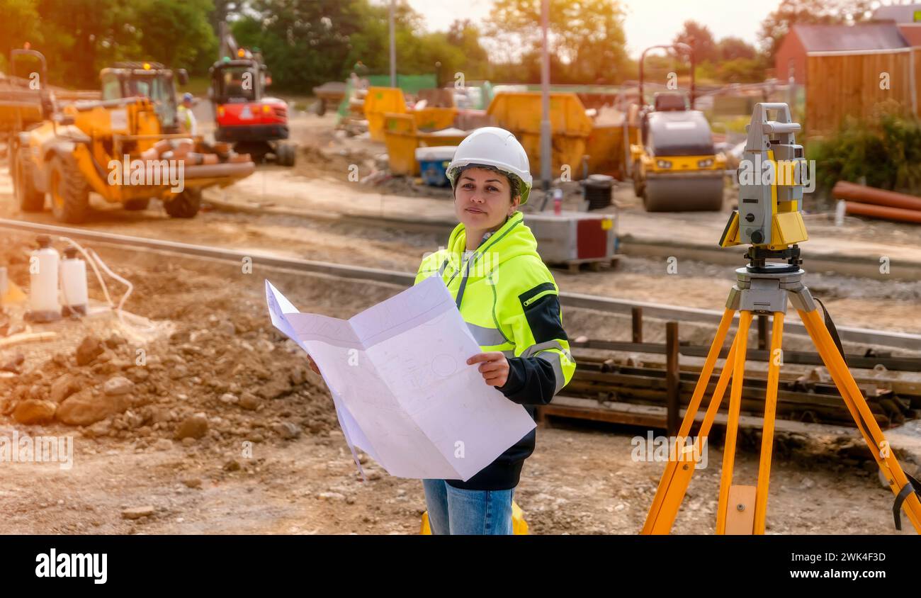 Female site engineer surveyor working with theodolite total station EDM ...