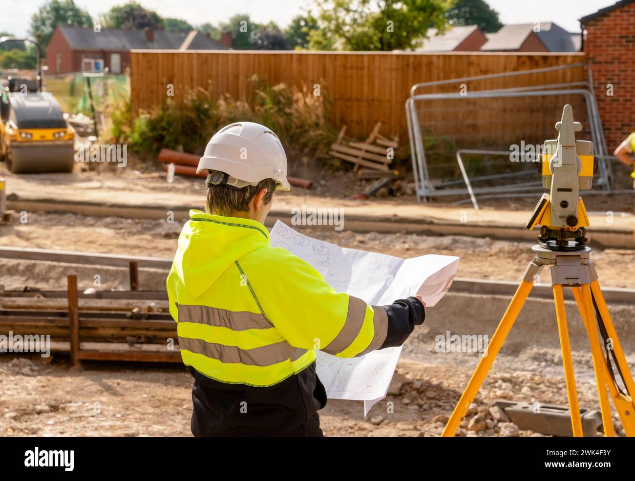 Female site engineer surveyor working with theodolite total station EDM ...
